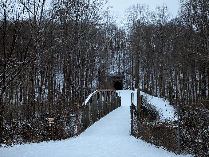 This snow-covered bridge leads visitors to the tunnel's entrance, like crossing the threshold between the ordinary world and the supernatural.