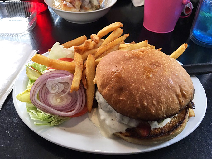 This isn't just a burger &ndash; it's a towering monument to the art of lunch, complete with a supporting cast of golden fries worthy of their own standing ovation.