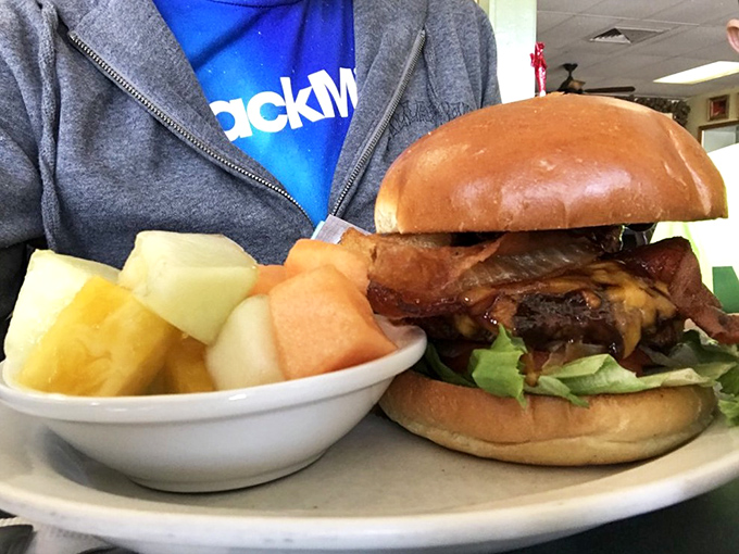 The burger that silences conversation. Notice the fresh fruit side&mdash;that's called balance, my friends, that's called sophistication.