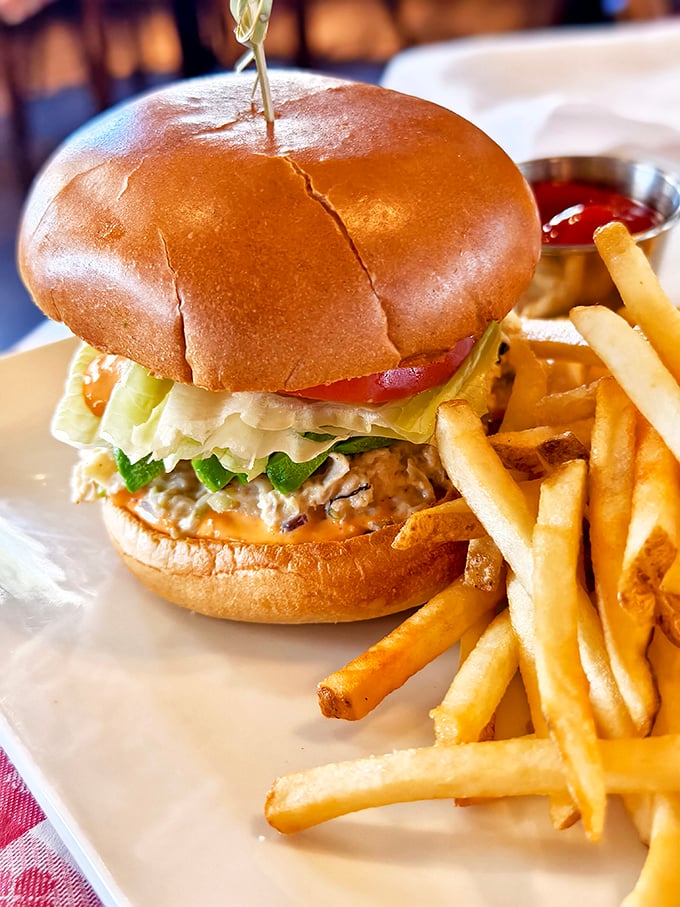 This isn't just a sandwich; it's architecture. A perfectly stacked seafood burger that makes you wonder why you'd ever order anything else.