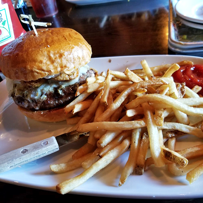 A burger that doesn't just satisfy hunger but resolves existential crises, paired with fries so perfectly golden they deserve their own Instagram account.