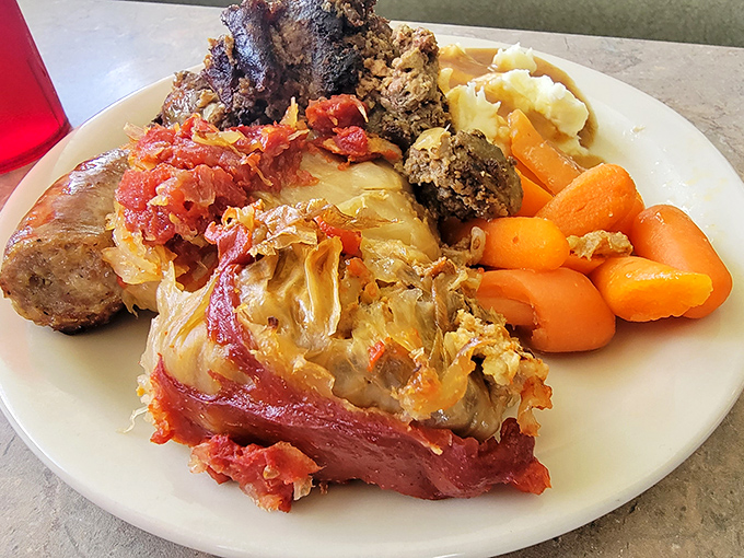 The legendary cabbage rolls—tender cabbage embracing seasoned meat and rice, bathed in tomato sauce that could make a vegetarian reconsider their life choices.