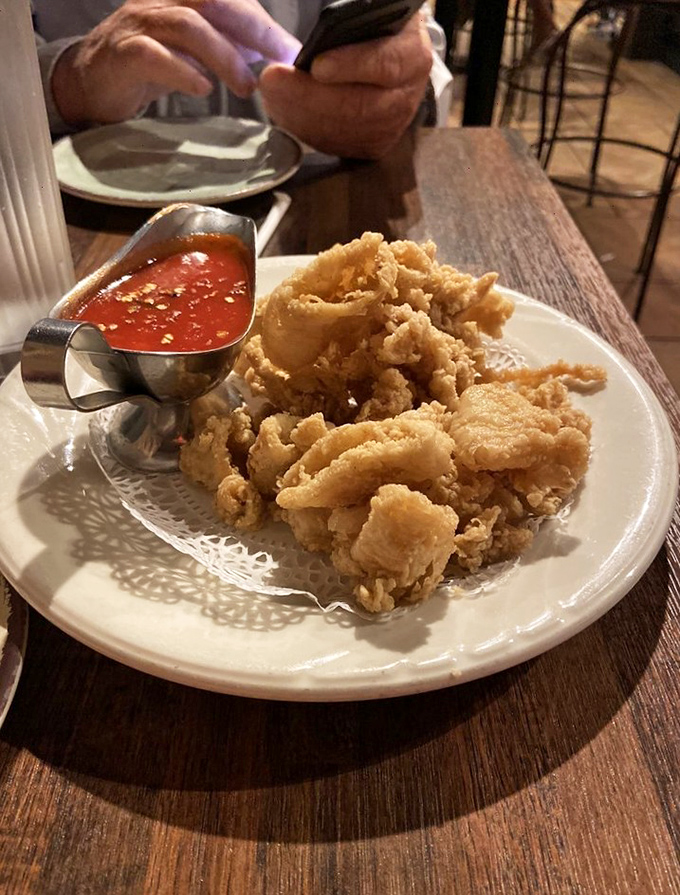 Golden-fried calamari that shatters with each bite, served with marinara so vibrant it could jumpstart your day better than that morning espresso.