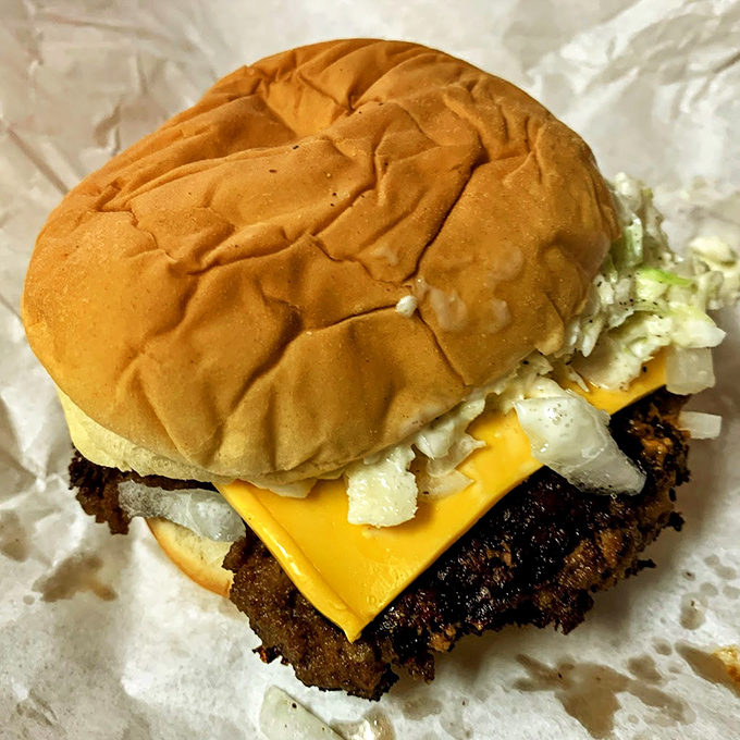 Crispy-edged patty, melty American cheese, and a perfectly toasted bun &ndash; the holy trinity of cheeseburger perfection in its natural habitat.