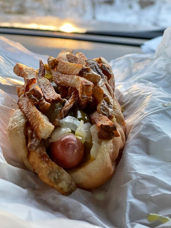 The classic Chicago-style hot dog in its paper blanket, sport peppers standing at attention like tiny green soldiers guarding flavor.
