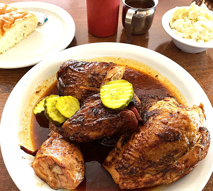 Smoke-kissed chicken that proves poultry deserves its place in the barbecue pantheon. Those pickles aren't just garnish—they're essential supporting actors.