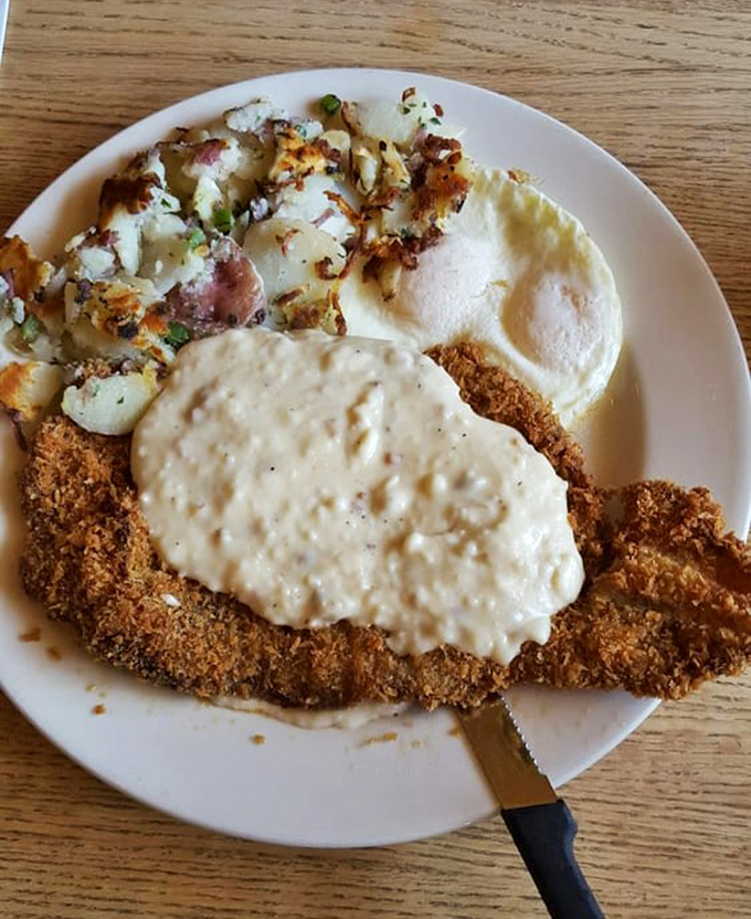 Country-fried steak smothered in gravy&mdash;where comfort food meets art form. The kind of meal your cardiologist warns you about but secretly craves.