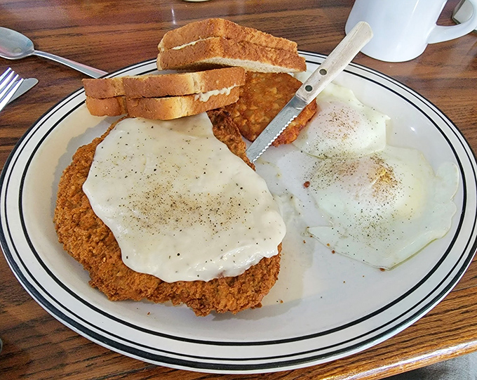Country-fried steak smothered in gravy with eggs on the side&mdash;the kind of breakfast that makes you want to build a barn afterward, or at least take a nap.
