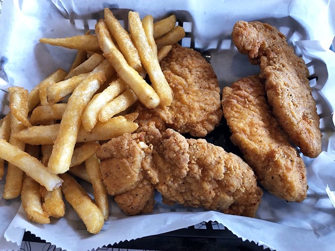 Fried chicken tenders that could make the Colonel salute, paired with fries so perfectly golden they deserve their own trophy.