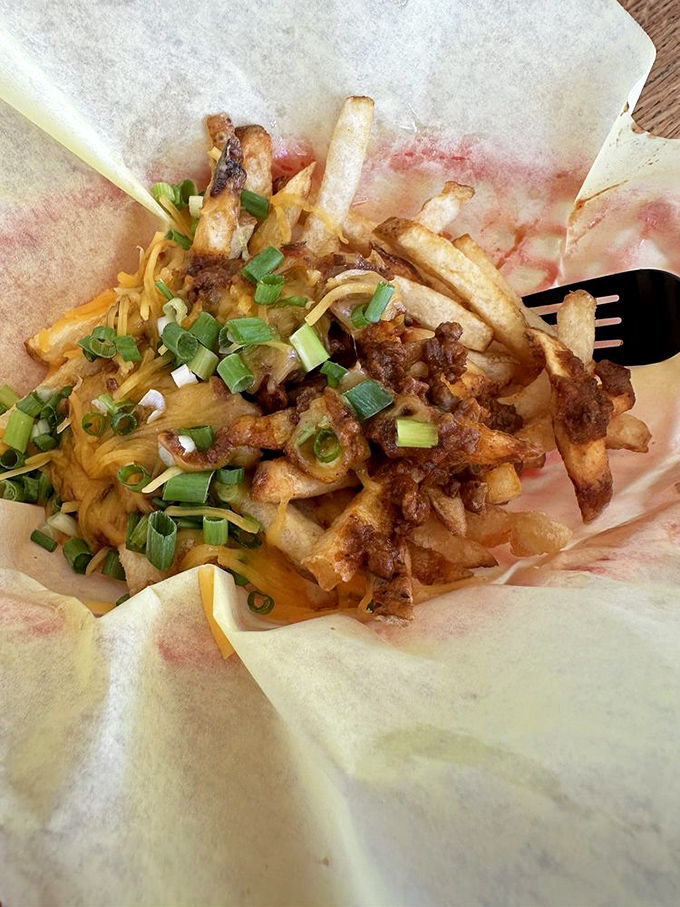 These loaded fries aren't just wearing cheese and chili&mdash;they're flaunting them like vintage designer labels. Fork required, napkins essential, regrets impossible.