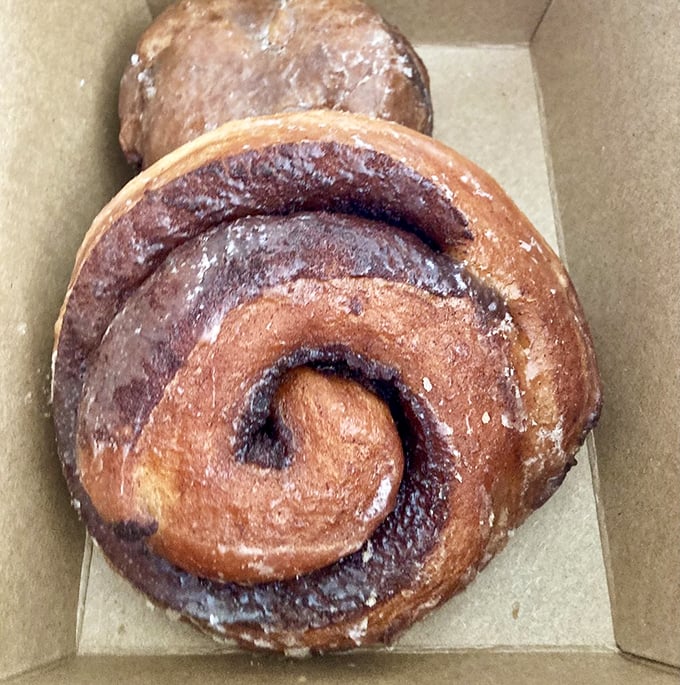 The cinnamon roll's hypnotic spiral practically whispers, "Follow me into deliciousness." Resistance is futile, calories be damned.