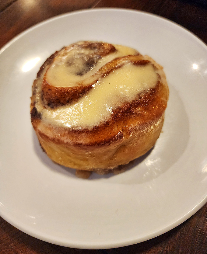 This isn't just any cinnamon roll&mdash;it's the kind that makes you consider ordering a second before you've finished the first, with swirls of cinnamon and glossy icing.