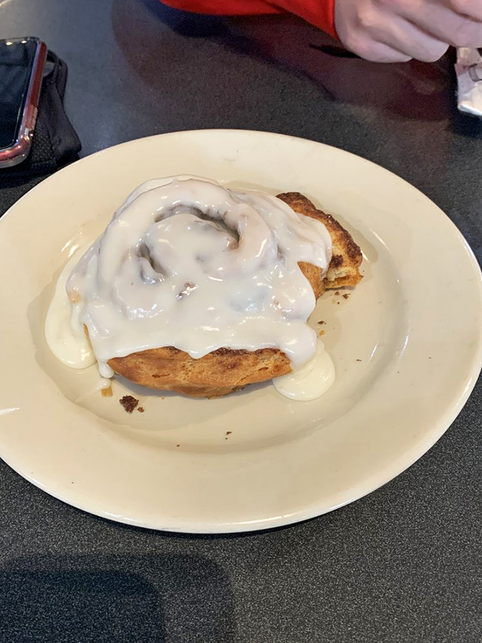 This isn't just a cinnamon roll&mdash;it's a spiral-shaped love letter to your taste buds, wearing its cream cheese frosting like a decadent winter coat.