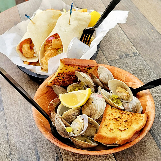 These garlic steamed clams arrive swimming in a broth that could convert even the staunchest landlubber.