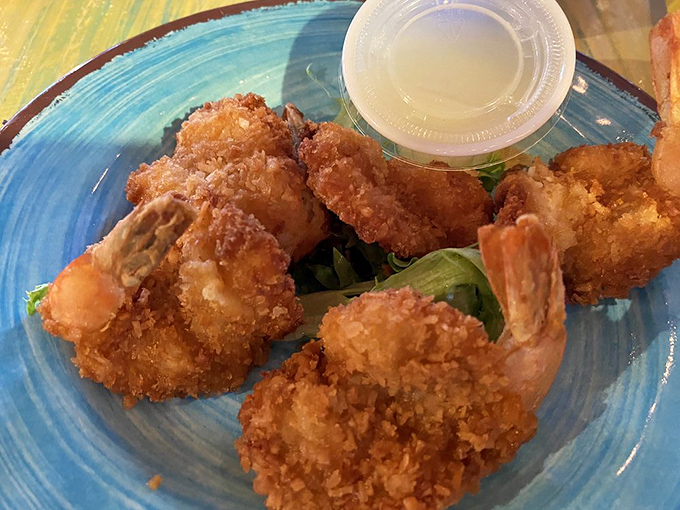 Golden-brown coconut shrimp that crunch like you're biting into happiness itself. Served on a bed of greens that you'll probably ignore completely.
