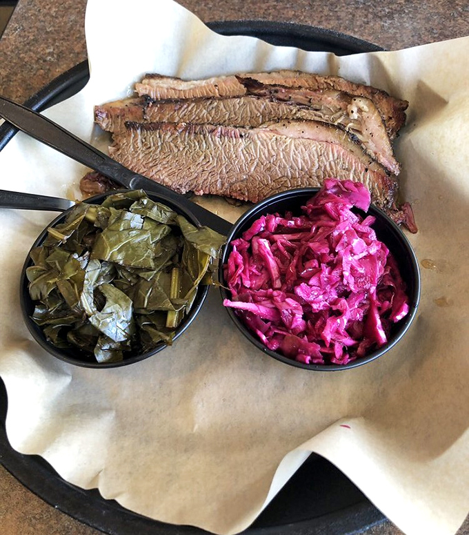 The holy trinity: brisket, collards, and something pink that's definitely not your grandmother's coleslaw. Soul food that speaks directly to your better angels.