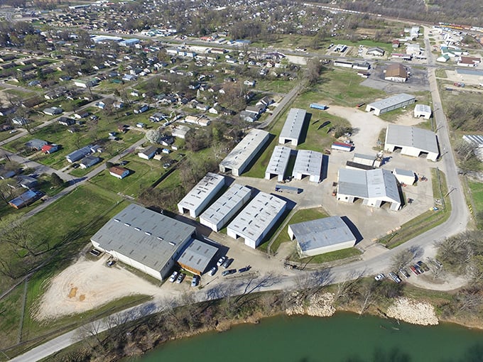 Industrial practicality meets natural beauty where business complexes border waterways, showcasing Poplar Bluff's balance of commerce and countryside.