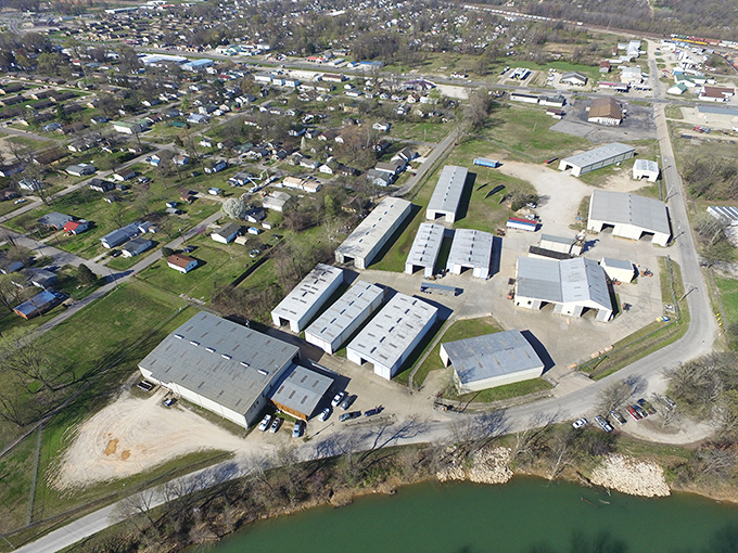 Industrial practicality meets natural beauty where business complexes border waterways, showcasing Poplar Bluff's balance of commerce and countryside.