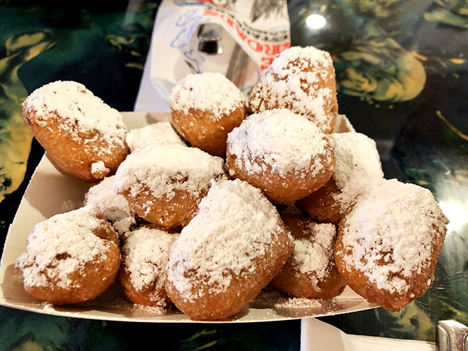 Corn fritters dusted with powdered sugar&mdash;little golden orbs of joy that somehow make waiting for your seafood an event itself.