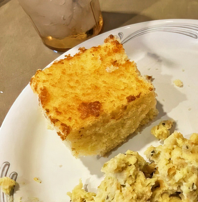Golden cornbread squares that crumble like edible sunshine, warm enough to melt butter on contact instantly.