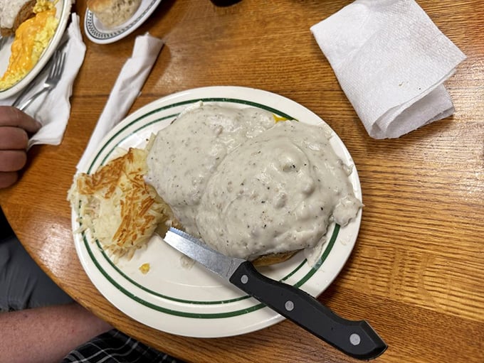 Country gravy blankets this biscuit like a warm Southern hug. Comfort food architecture at its finest&mdash;sturdy foundation, generous middle, satisfying finish.