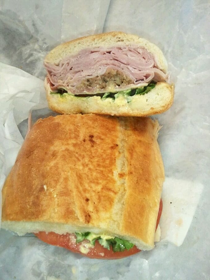 Sandwich architecture at its finest&mdash;layers of ham, pickles, and more nestled in Cuban bread. The cross-section reveals the careful construction of flavor.