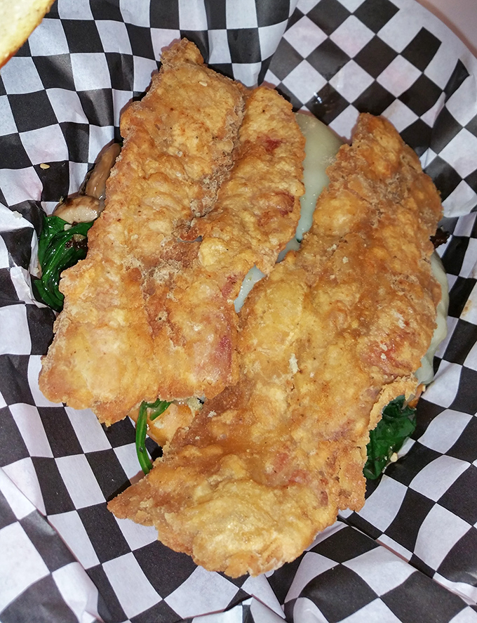 Crispy chicken that's had a proper introduction to the deep fryer. The checkered paper is less a serving vessel and more a victory flag.