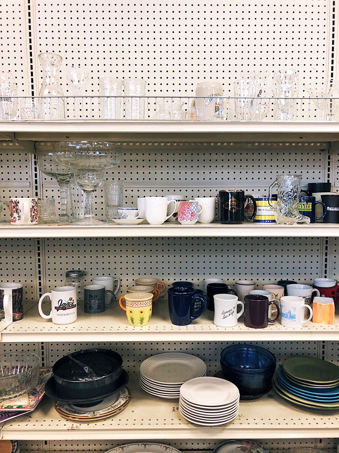 Mismatched mugs and perfectly stacked plates create a ceramic mosaic, each piece waiting to star in your next dinner party.