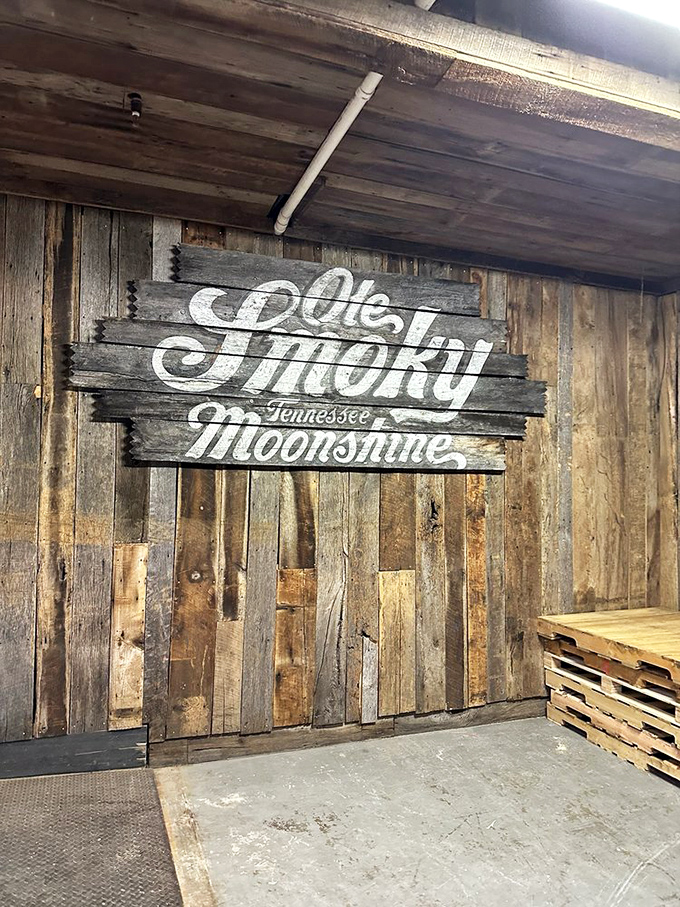 The wall says it all! This weathered wooden sign proudly announces what generations of mountain folks had to keep secret—Tennessee moonshine, now legally yours for the tasting.