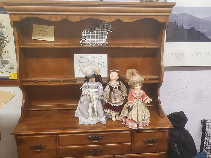 Porcelain faces from another era gaze out from their wooden perch, silently hoping you'll be their next caretaker.