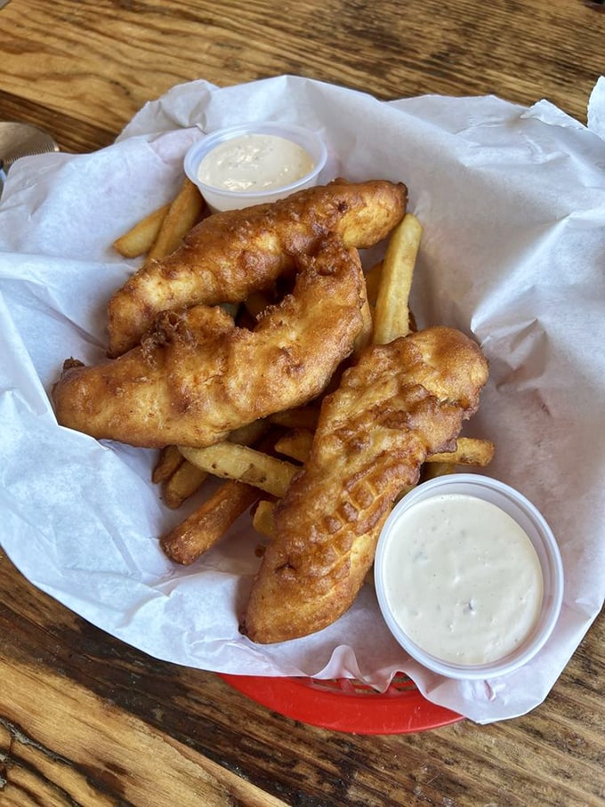 Beer-battered fish so golden and crisp it practically winks at you, with fries that understand their supporting role perfectly.