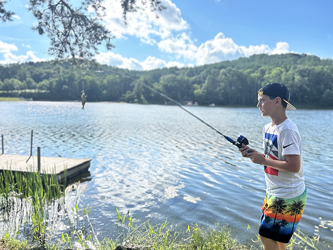 The timeless dance between angler and fish plays out on Lake Hope's shores. That look of concentration says it all.