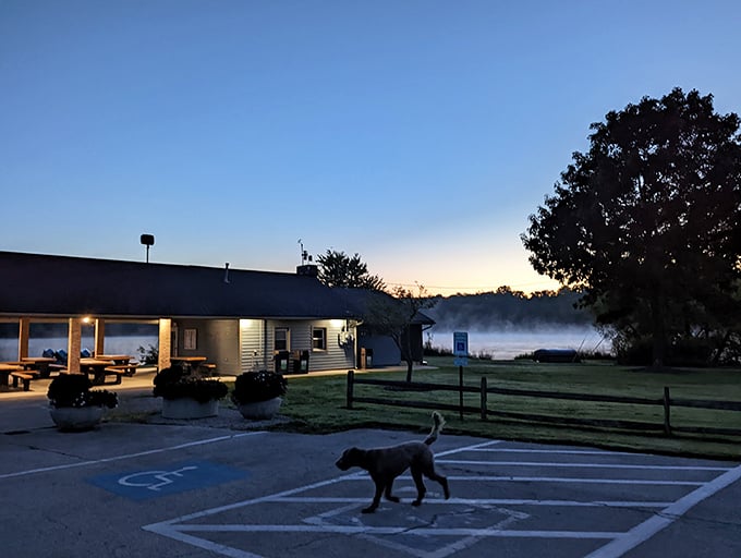 Dawn's misty curtain rises on Sunny Lake's daily performance, with the park building serving as nature's perfect stage.