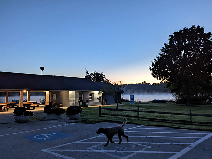 Dawn's misty curtain rises on Sunny Lake's daily performance, with the park building serving as nature's perfect stage.