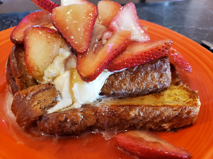French toast transformed into dessert-for-breakfast, with strawberries and cream creating a morning indulgence that makes Monday feel like Saturday.
