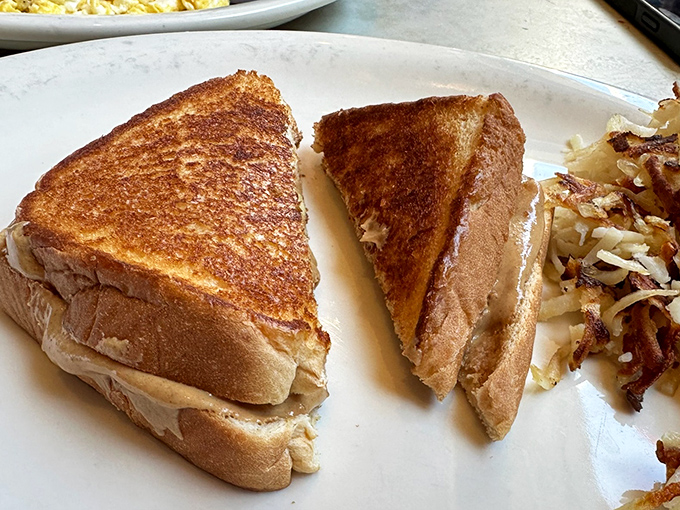 The humble grilled sandwich elevated to art form. That golden-brown exterior hides a peanut butter filling that would make Elvis himself nod in approval. 