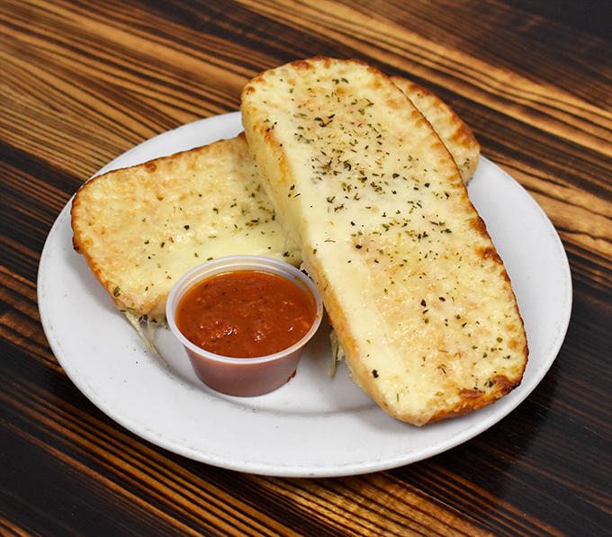 Garlic cheese bread that could make a vampire reconsider its life choices&mdash;crisp exterior, pillowy inside, and enough cheese to make Wisconsin proud.