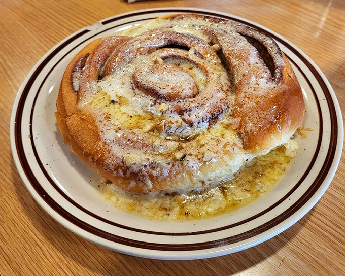This cinnamon roll isn't just big &ndash; it's "needs its own zip code" big. Swimming in buttery cinnamon sauce, it's the pastry equivalent of a warm hug.
