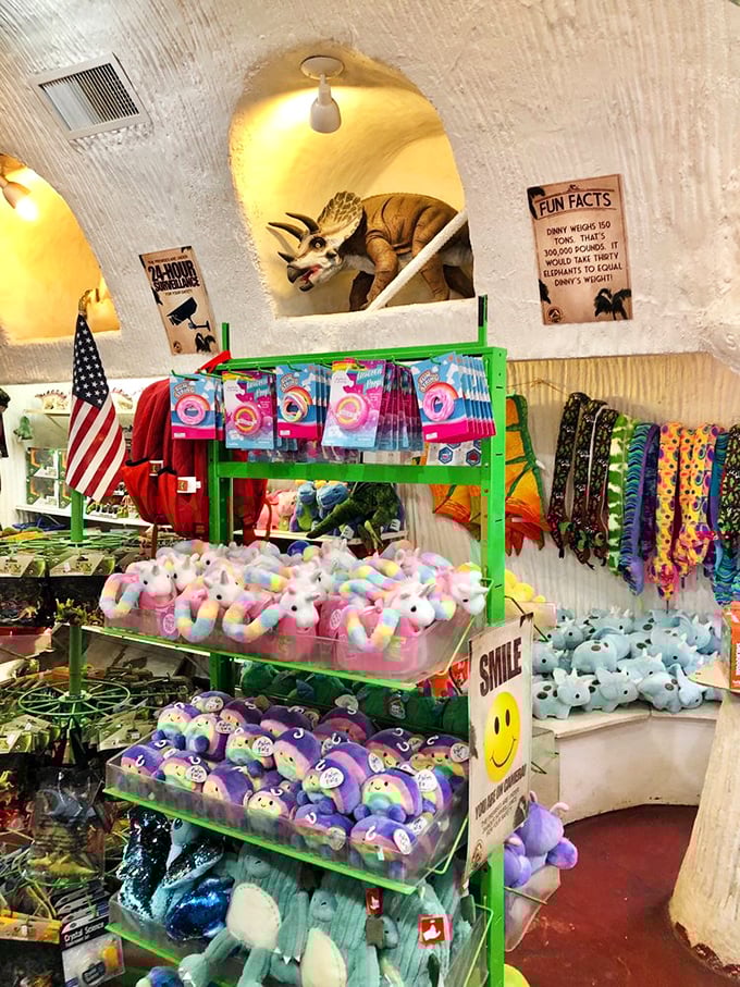 Inside Dinny's belly, a treasure trove of dino-merchandise awaits, complete with plush prehistoric pals and a Triceratops keeping watch.
