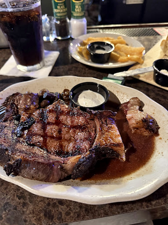 This isn't just a pork chop; it's a masterclass in meat preparation. The grill marks tell stories of perfect timing and temperature.