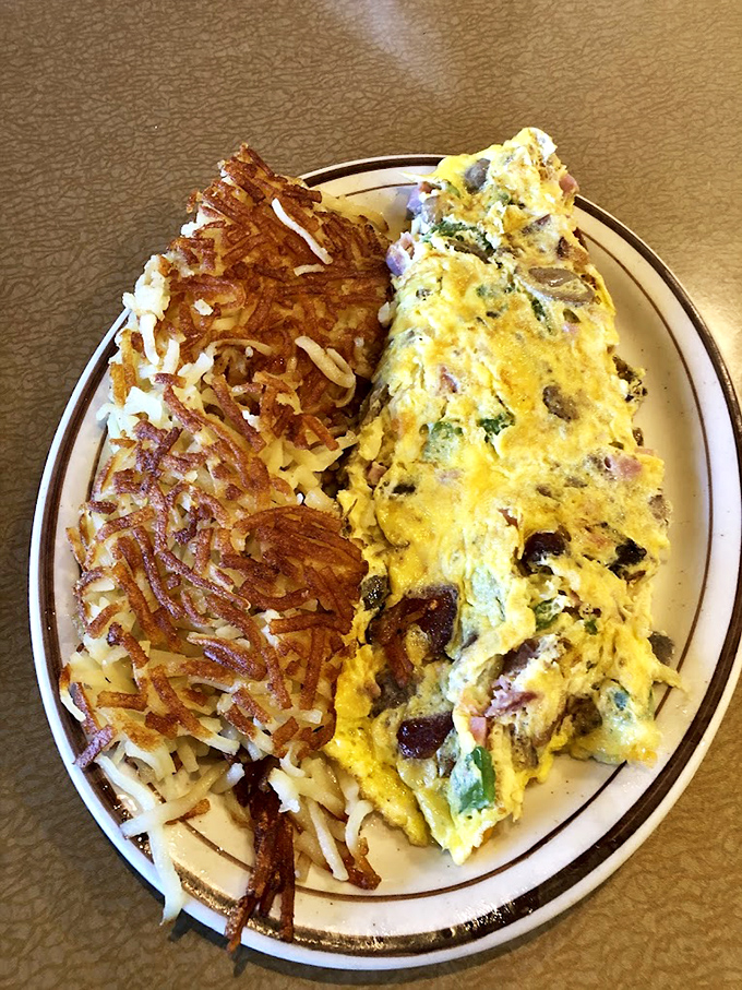 The omelet that ate Manhattan! Packed with enough fillings to qualify as a meal for two, alongside hash browns crisped to golden perfection.