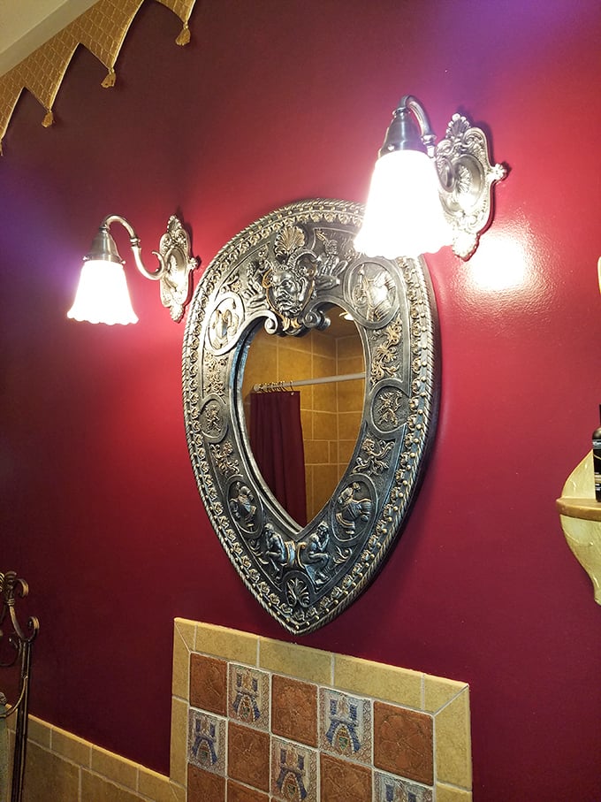 Even the bathroom mirror belongs in a royal treasury&mdash;heart-shaped and ornate against rich crimson walls that would make Henry VIII feel at home.