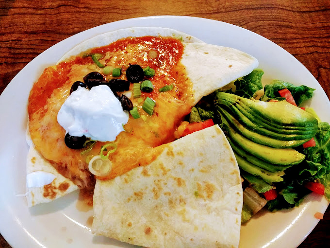 Huevos rancheros with perfectly sliced avocado&mdash;proof that California knows how to elevate breakfast without losing its soul.