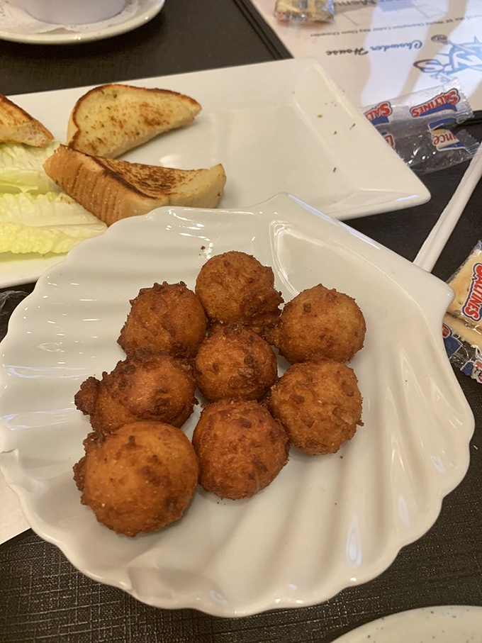 Hushpuppies so perfectly golden they should come with a warning: "May cause involuntary food noises." Crispy outside, fluffy inside&mdash;textbook perfection.