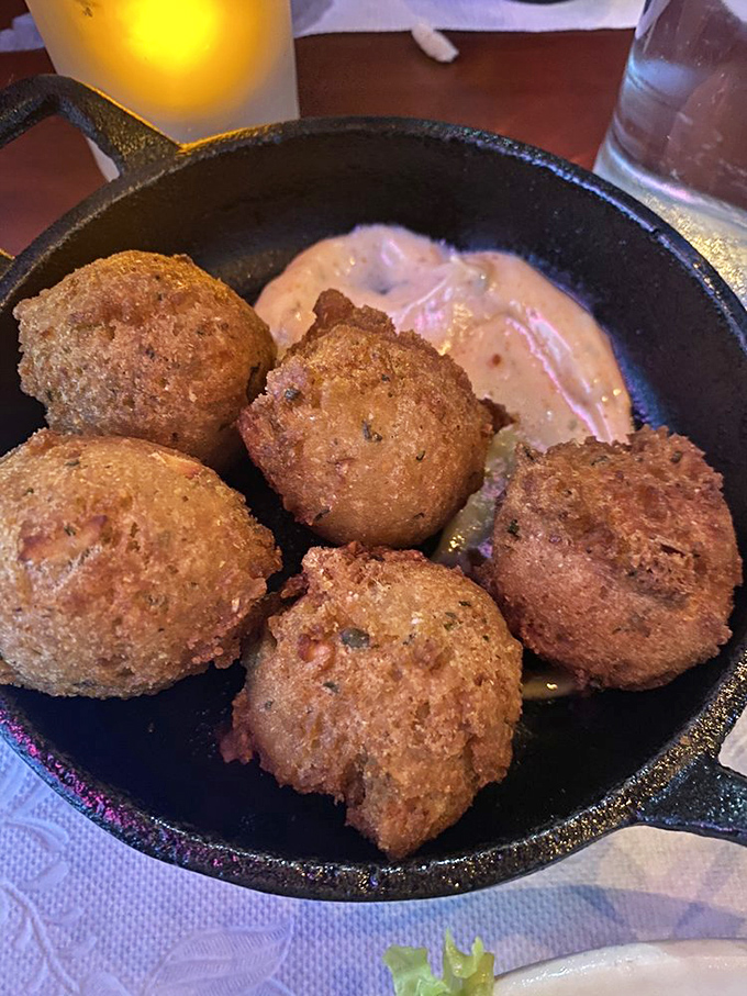 Crabmeat hushpuppies that would make your Southern grandmother weep with joy, served in a cast iron skillet because some traditions are sacred.
