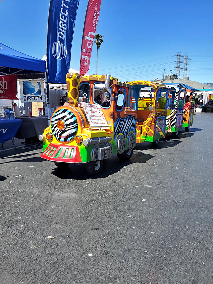 All aboard the bargain express! This whimsical kiddie train offers a moment of joy between haggling sessions.