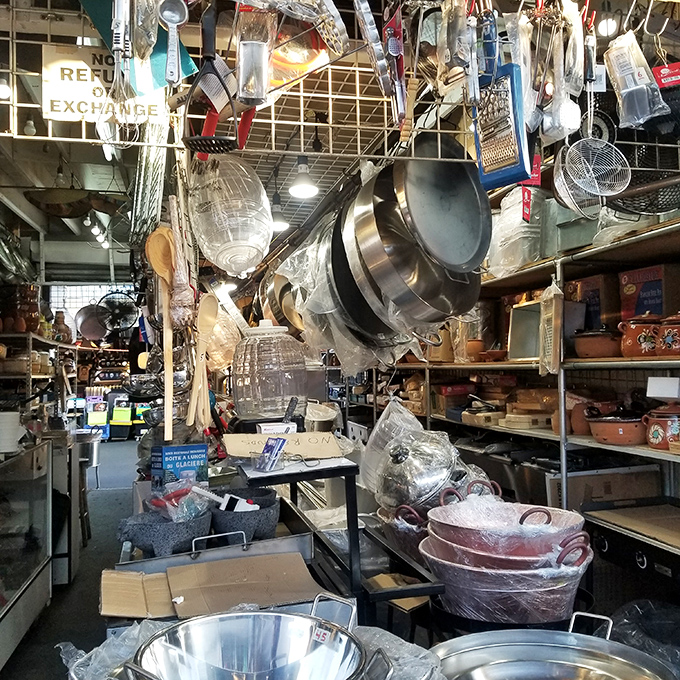 Kitchen gadget paradise where pots and pans dangle like metallic wind chimes, promising culinary adventures for cooks of all skill levels.
