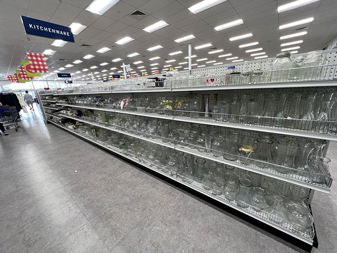 Glassware galore stretches endlessly, where grandma's crystal mingles with modern minimalism in beautiful transparent chaos.