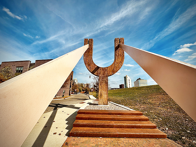 Dramatic perspective showcases The Slingshot's impressive scale, with wooden steps inviting visitors to climb into position for their imaginary launch.