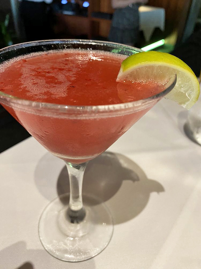 A ruby-red cocktail that whispers "vacation" even on a Tuesday, garnished with citrus that cuts through sweetness like a well-timed punchline.
